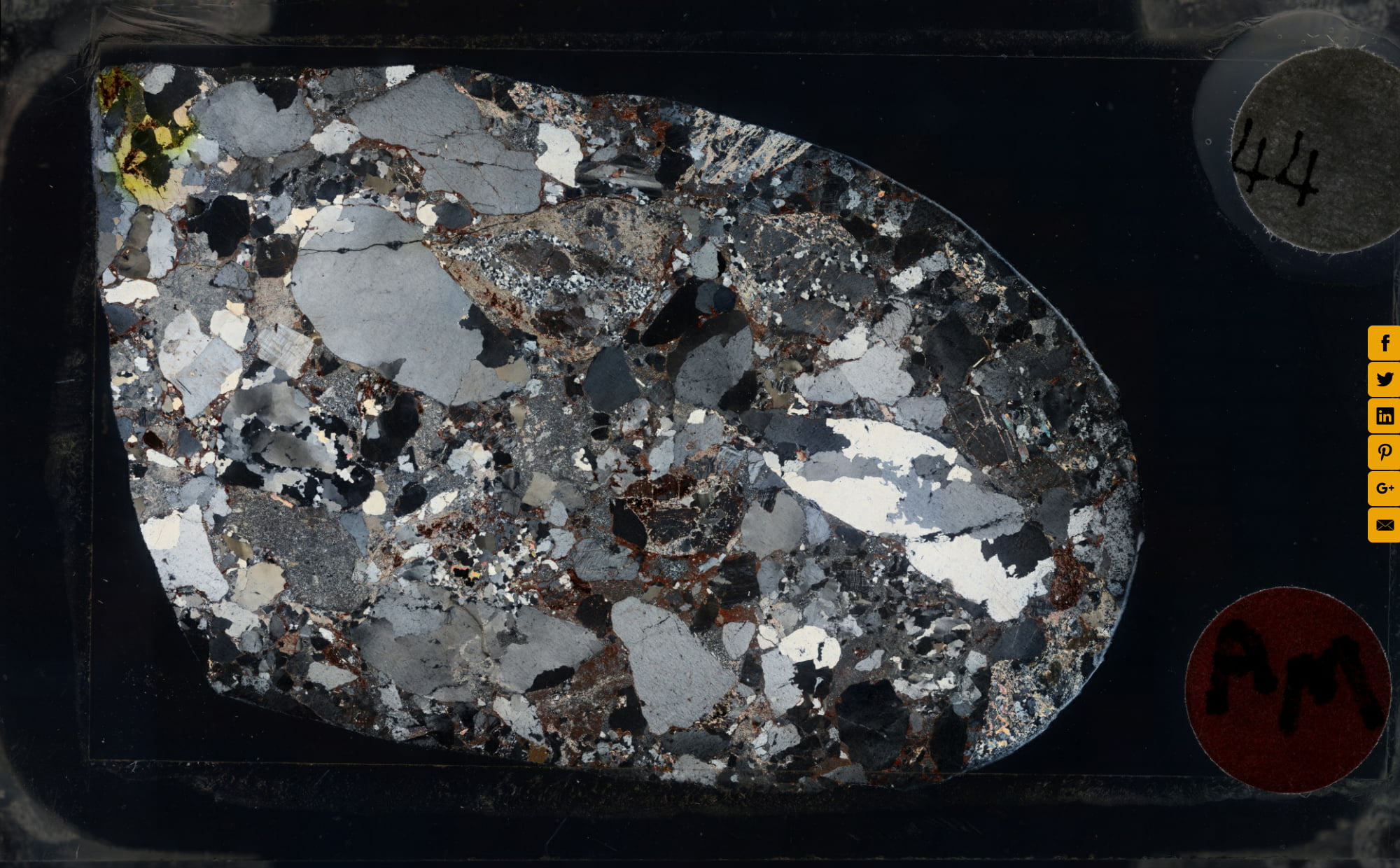 Conglomerate with Calcite Cement and Hematite Cement, Crossed Polars